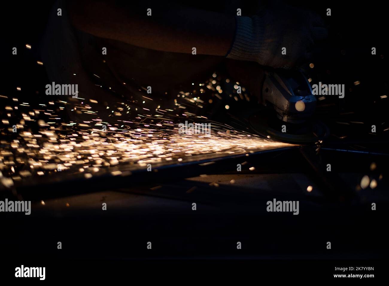 Grinding of steel. Sparks from metal. Hot particles. Small lights. Work ...
