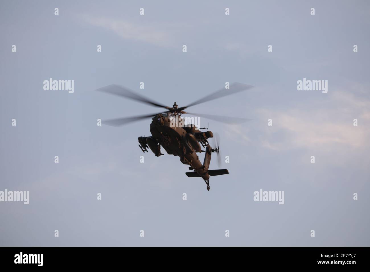 One of two U.S. Army AH-64E Apache helicopters conducts a flyover at ...
