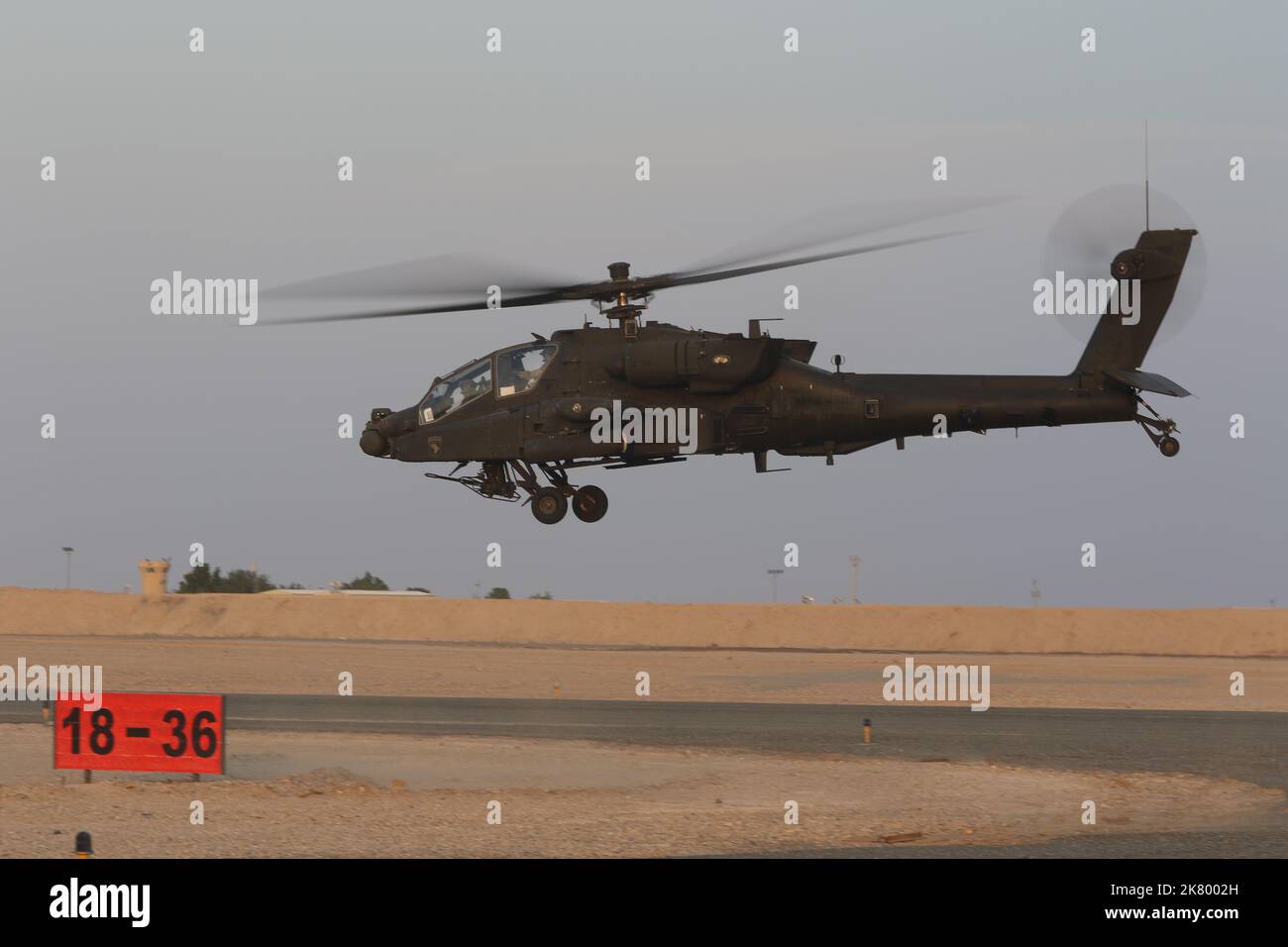 One of two U.S. Army AH-64E Apache helicopters conducts a brief landing ...