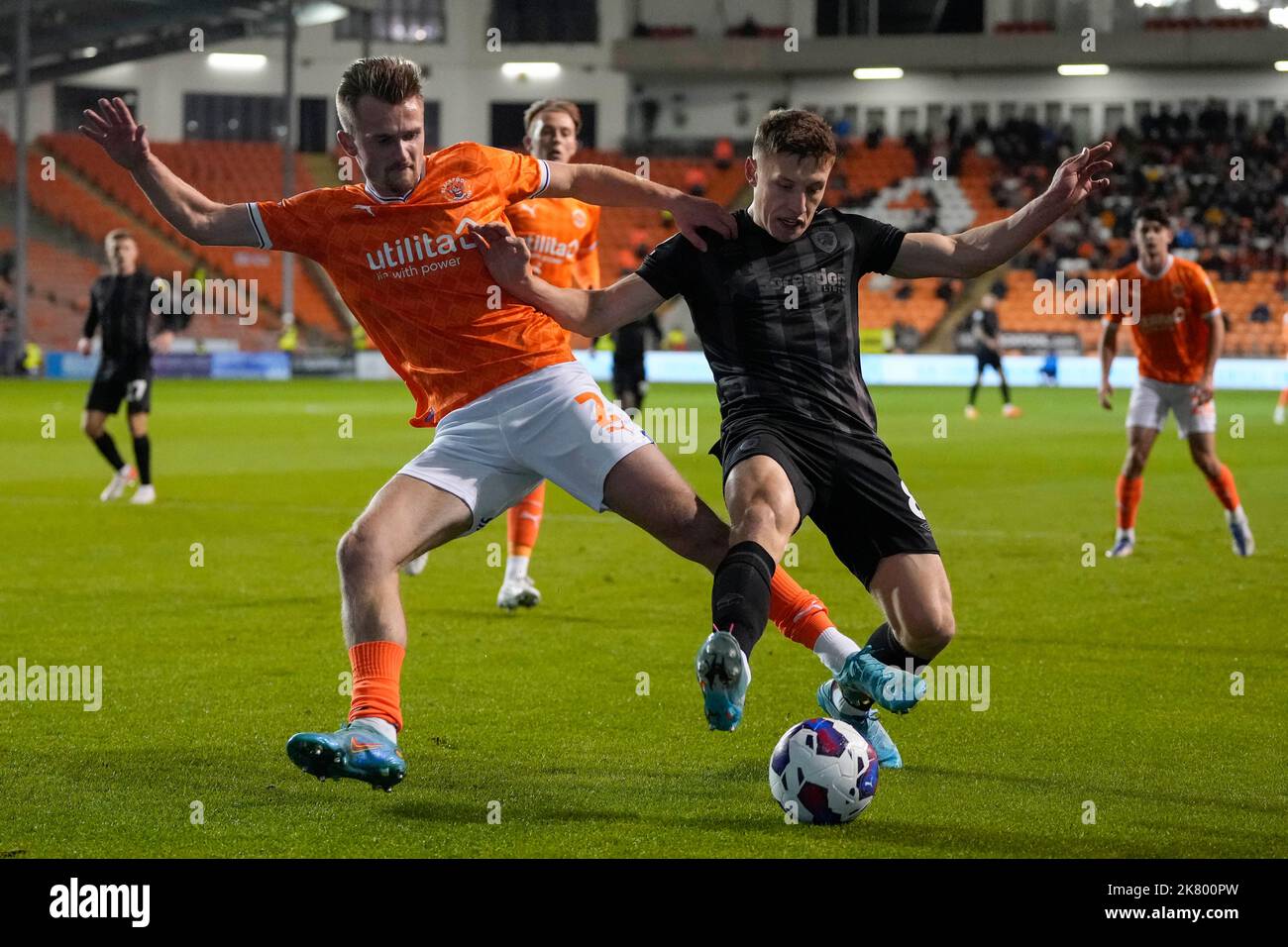 Callum Connolly #2 of Blackpool competes for the ball with Greg ...