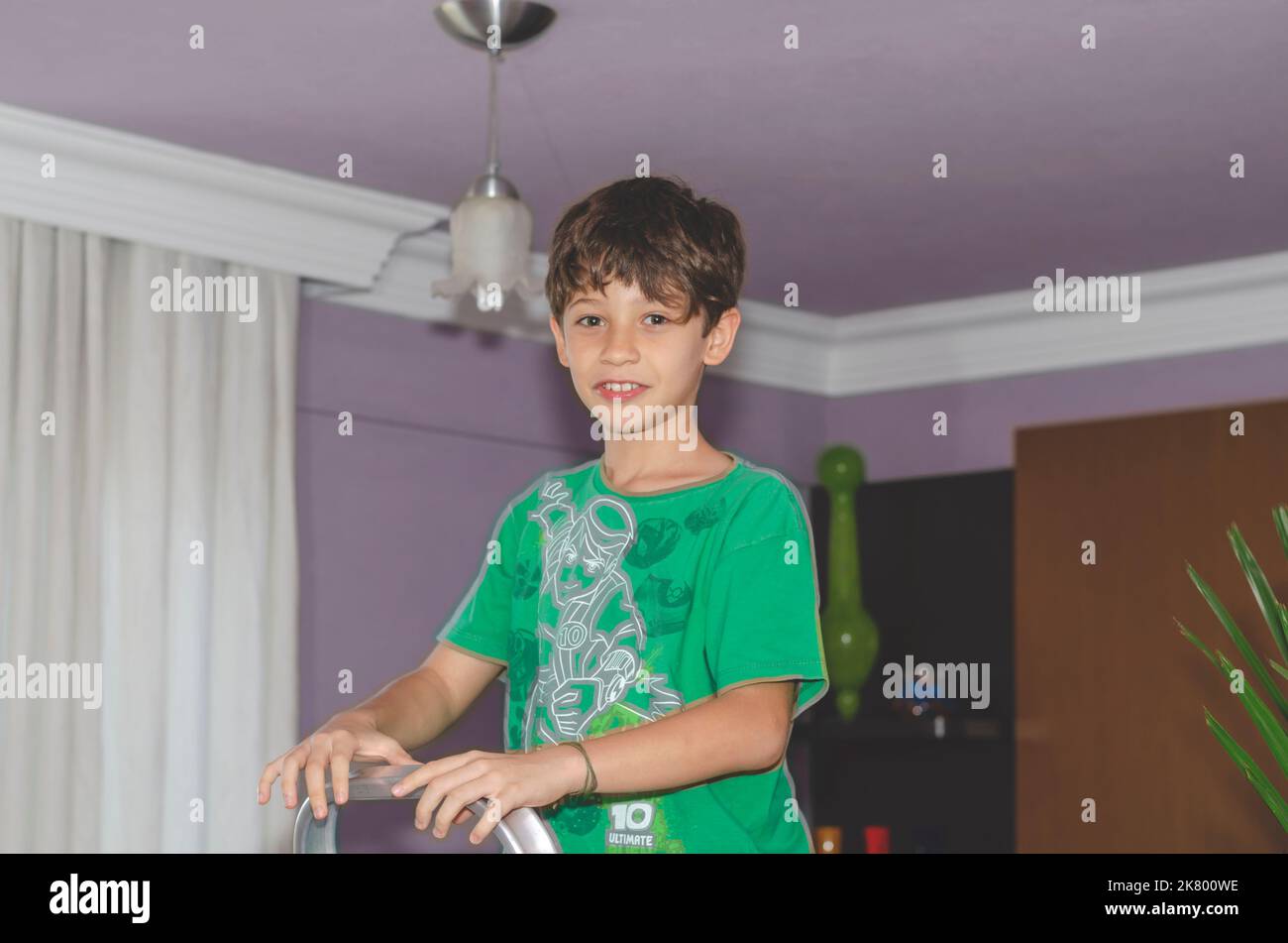 Portrait of a child climbing a stainless steel ladder. Skill at home ...