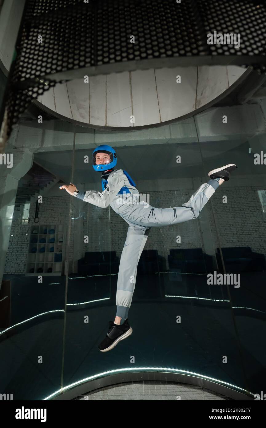 A woman flies in a wind tunnel. Free fall simulator Stock Photo - Alamy