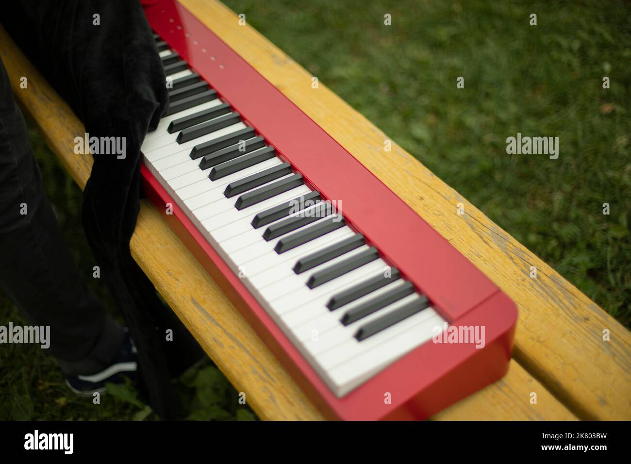 Red piano. Sound synthesizer. White keys. Electronic grand piano. Music ...