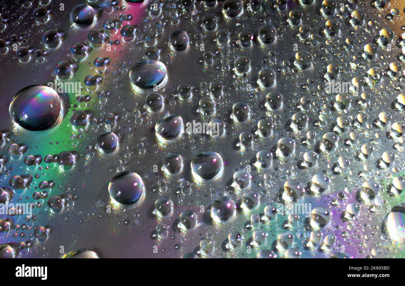 Rain Drops on the rainbow surface of a CD Stock Photo - Alamy