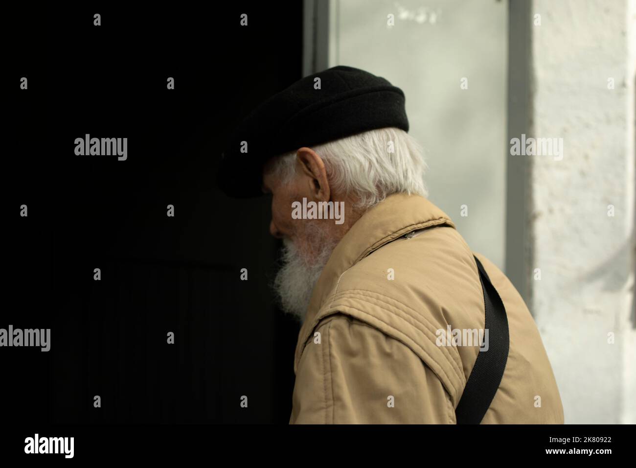 Old man enters house. Gray-haired man. Old man on street. Pensioner ...
