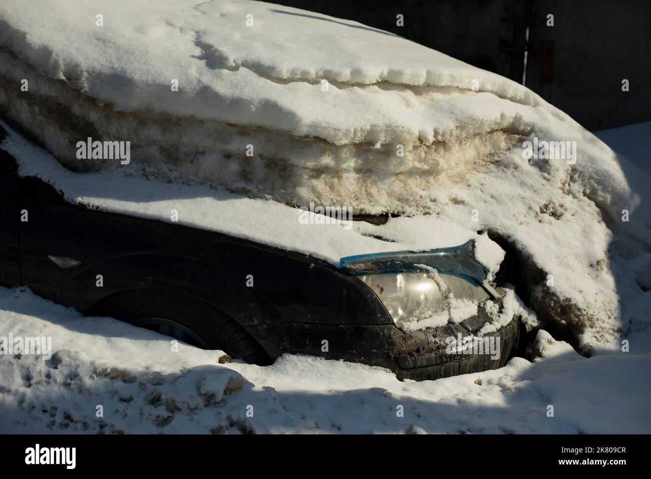 Car under snow. In winter in parking lot. Transport after snowfall ...