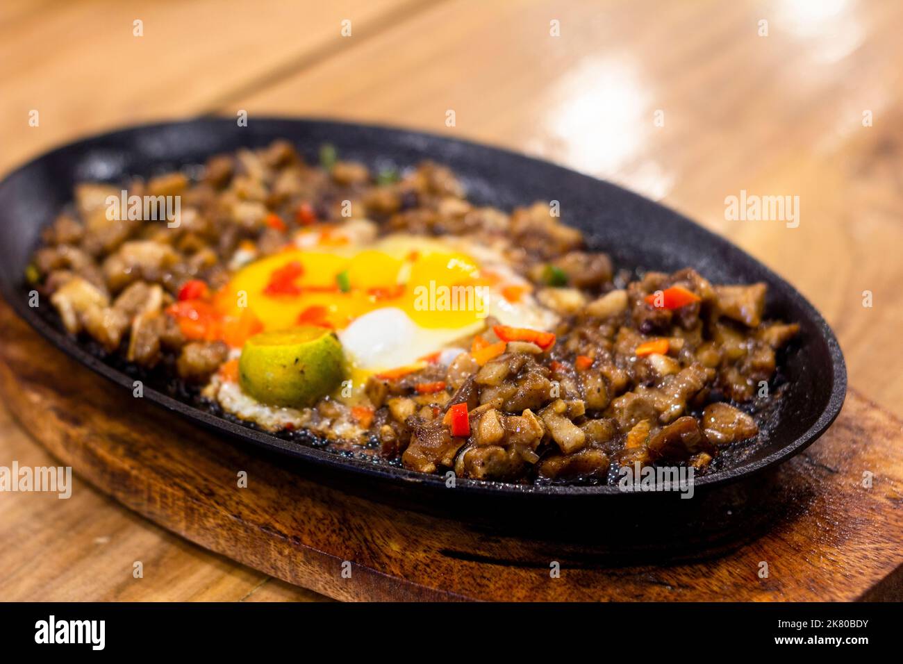 A steaming sizzling plate of Filipino sisig dish in Ozamiz City ...
