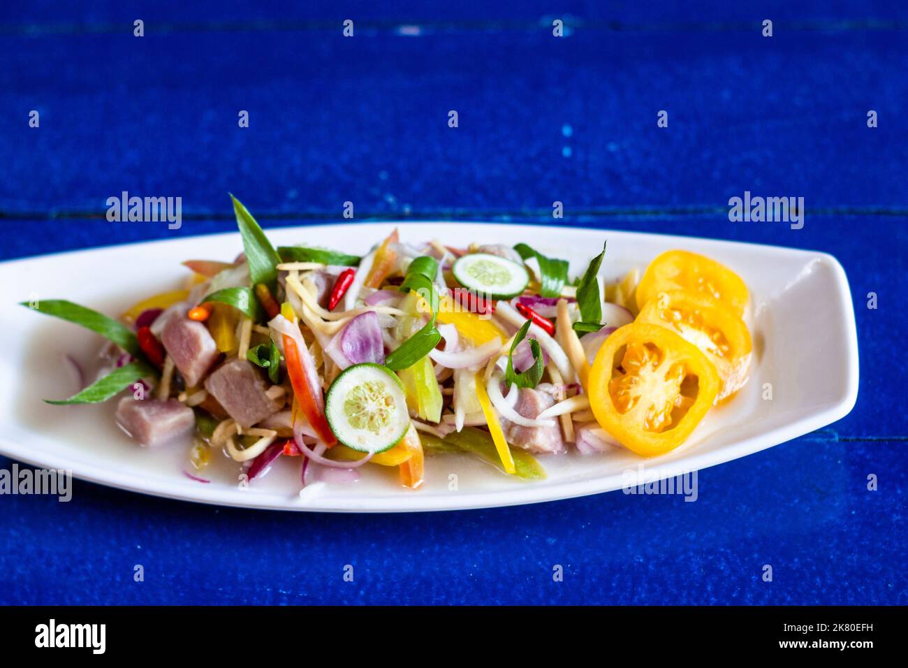 A dish of kinilaw which is raw fish in vinegar with added vegetables in ...