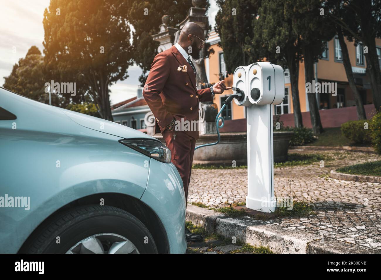 Side view of a dapper bald bearded black man in an elegant tailored ...