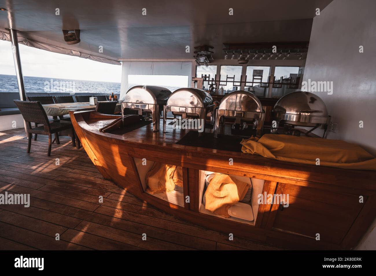 A wide-angle view of an empty ship restaurant interior with an ocean in ...