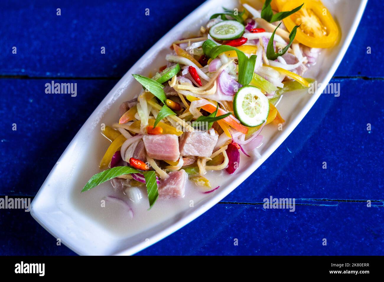 A dish of kinilaw which is raw fish in vinegar with added vegetables in ...