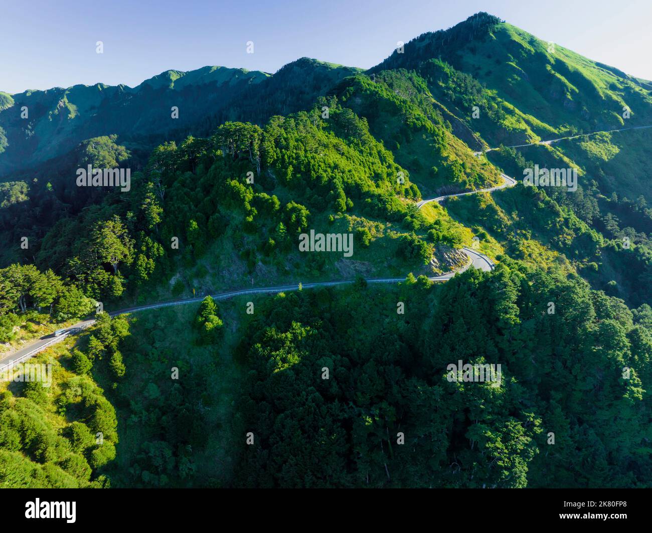 Aerial view of mountain road In beautiful green forest Stock Photo - Alamy