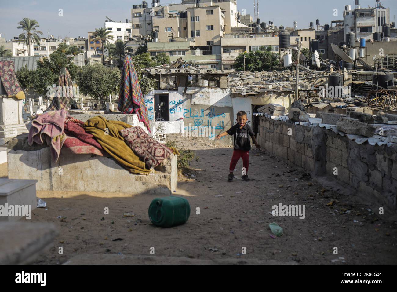 A Palestinian child plays in front of his house in Sheikh Shaban ...
