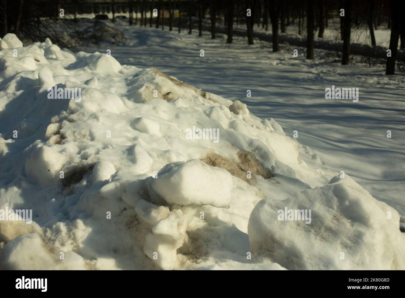 Snow removed from road. Pile of snow outside. Dirty roadside. Blocks of ...