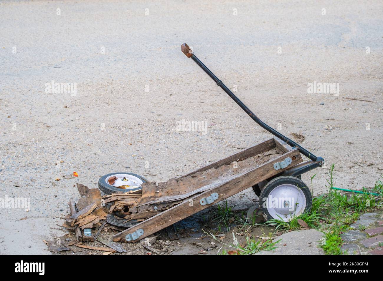Severely damaged wooden cart, apparently run over by a vehicle, on the ...