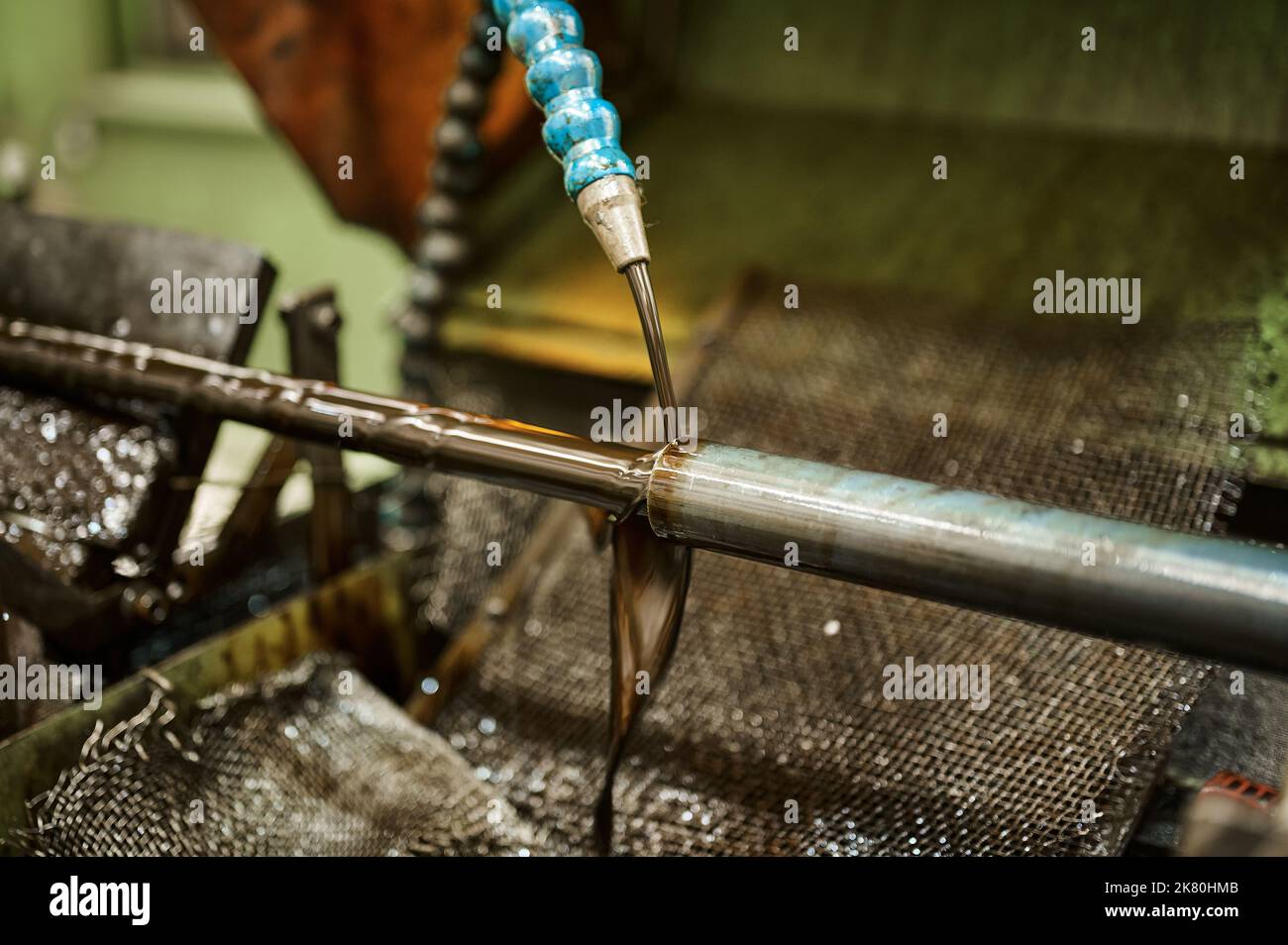 Liquid honing of drill rod with lubricant in workshop Stock Photo - Alamy