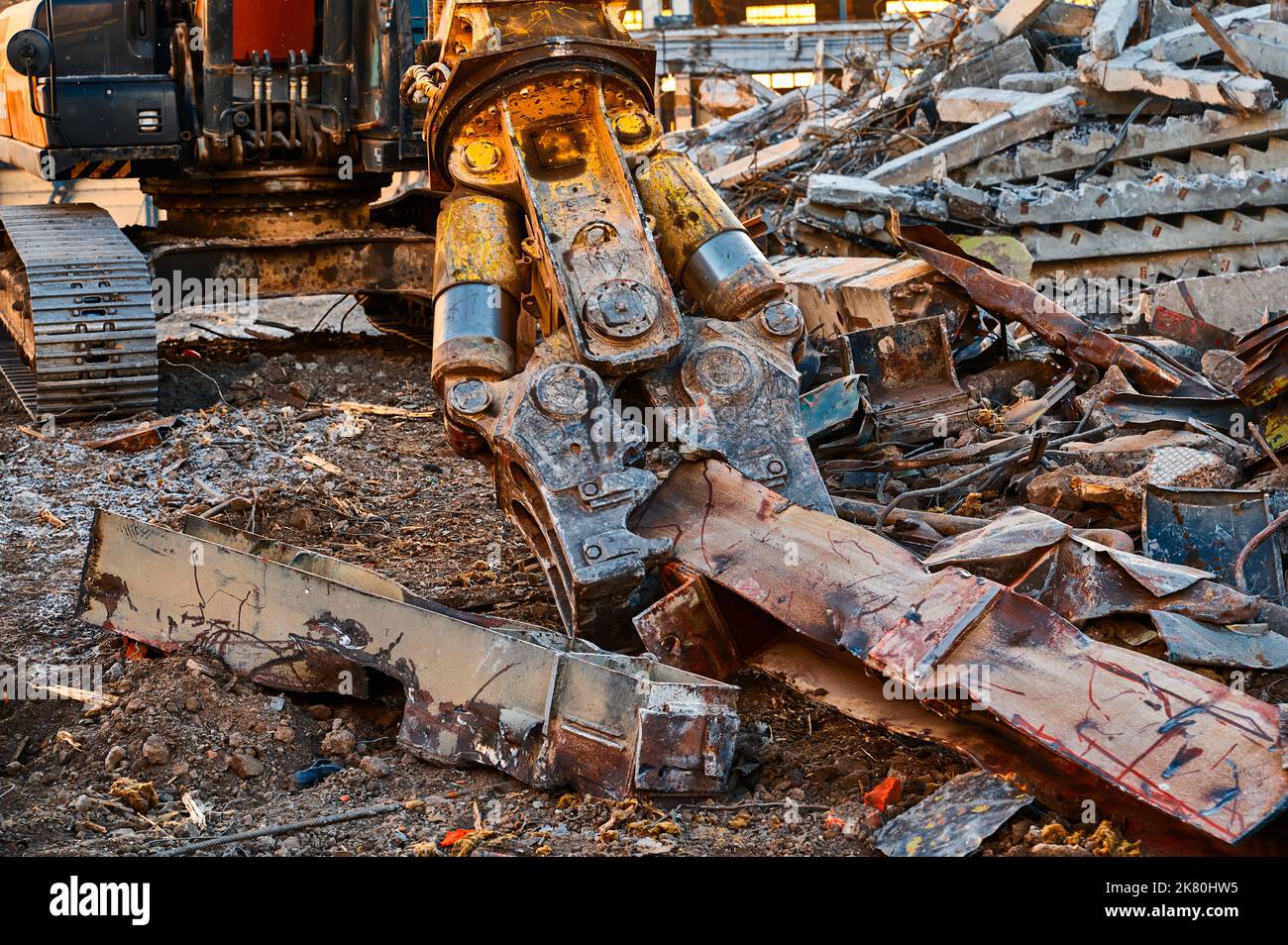 Hydraulic breaking shears cut through the steel beam. Demolition of ...