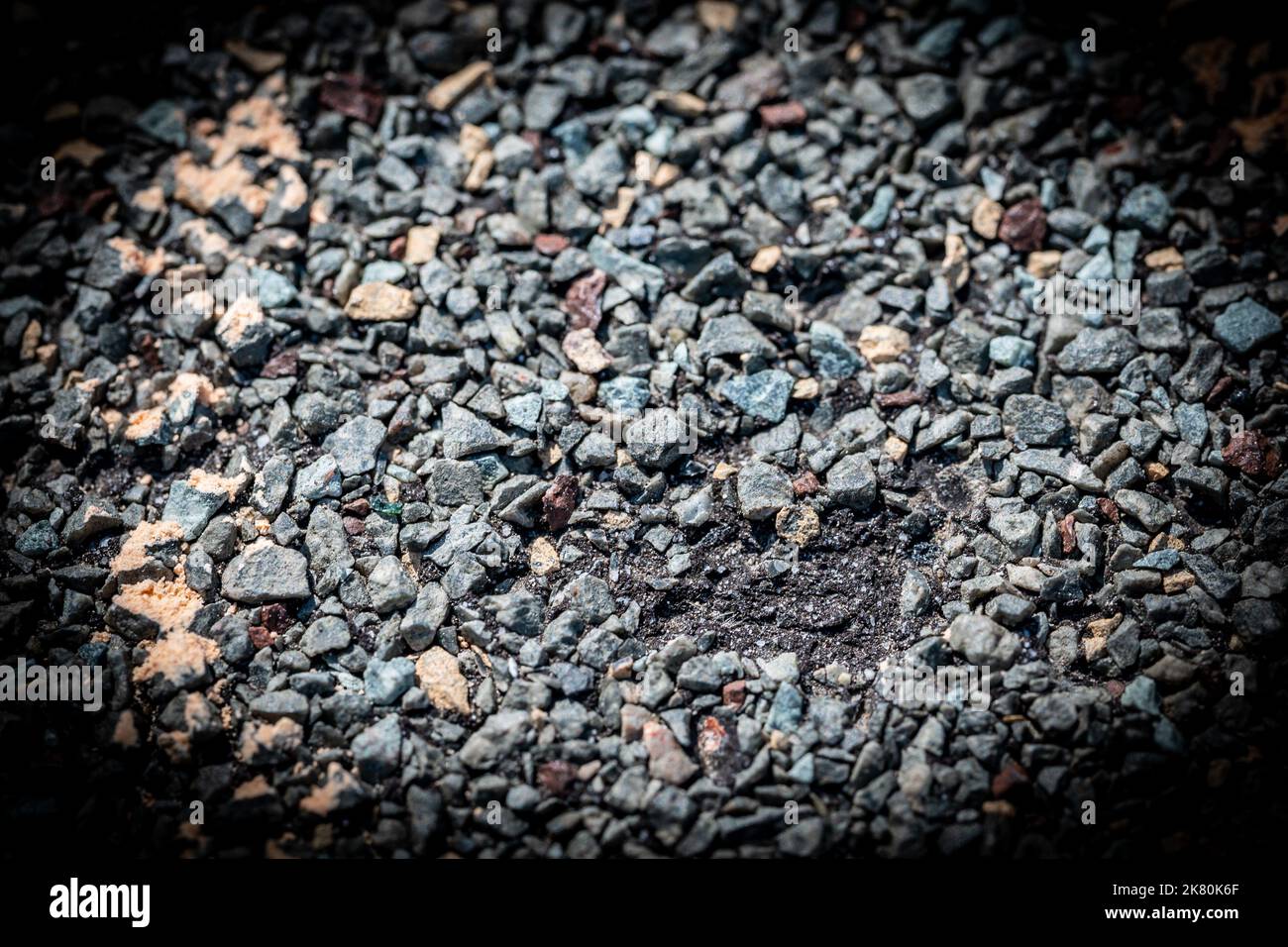 Macro of hail damage on a shingle residential roof circled with a chalk ...