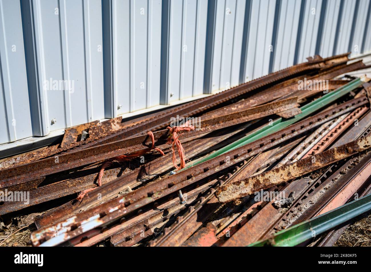 Pile of rusted steel fence posts on the ground Stock Photo - Alamy