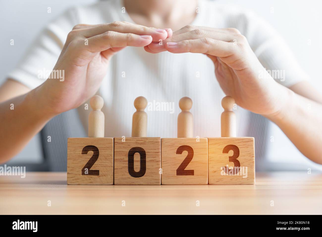 hand cover wooden man employees with 2023 Year block. Insurance ...