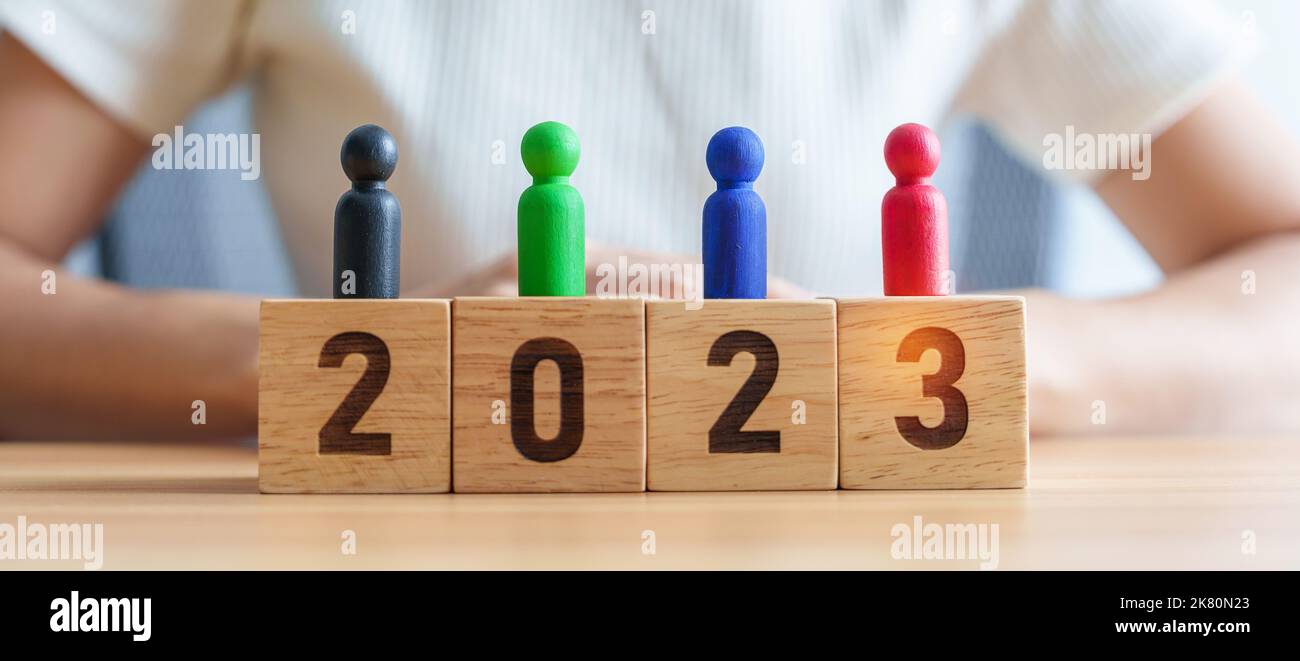 Colorful wooden people with 2023 Year blocks on tablefor diverse ...