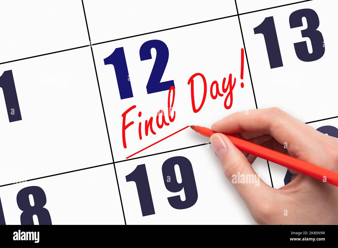12th day of the month. Hand writing text FINAL DAY and drawing a line ...