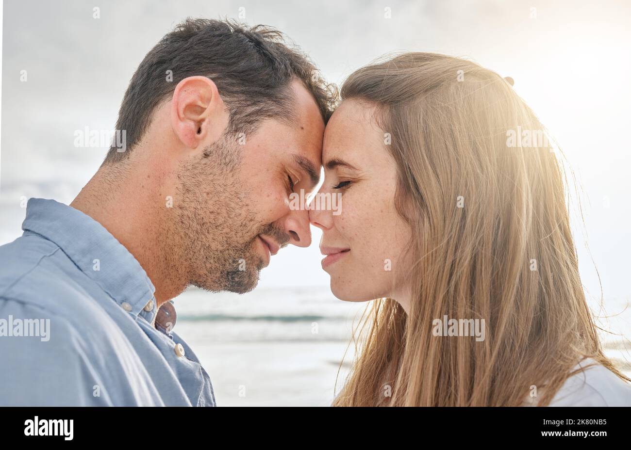 Travel, love and couple relax at sunset, embracing in intimate moment ...