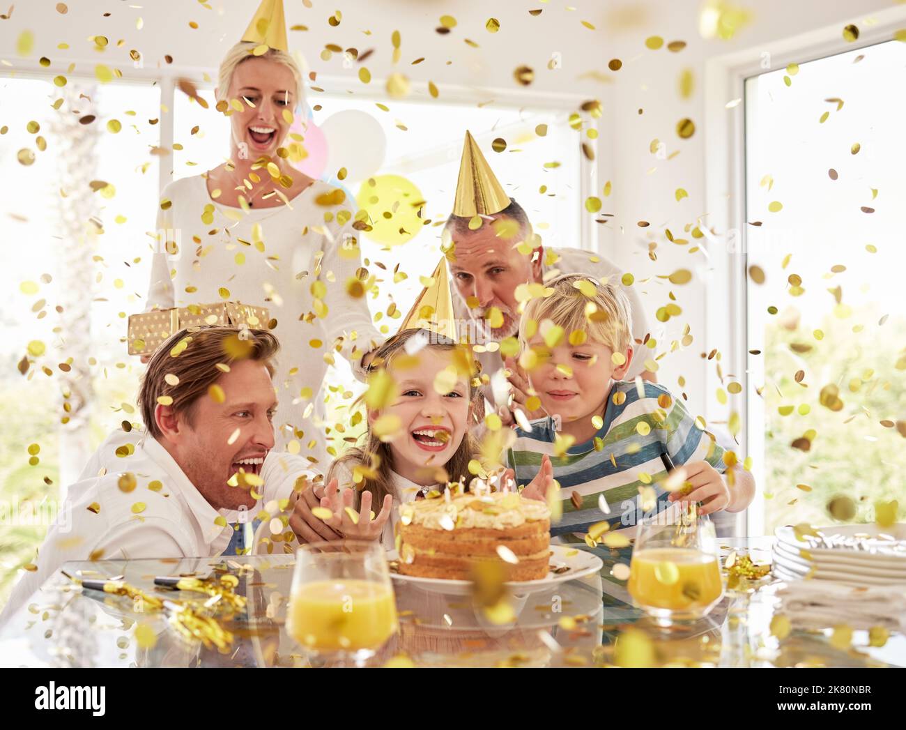 Kids happy birthday party, confetti surprise and family home with cake ...