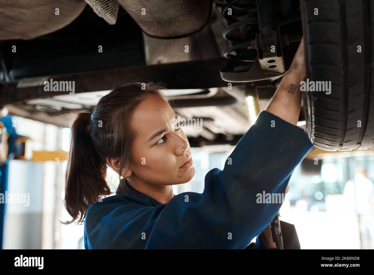 Problem solving is a huge part of the job. a female mechanic working ...