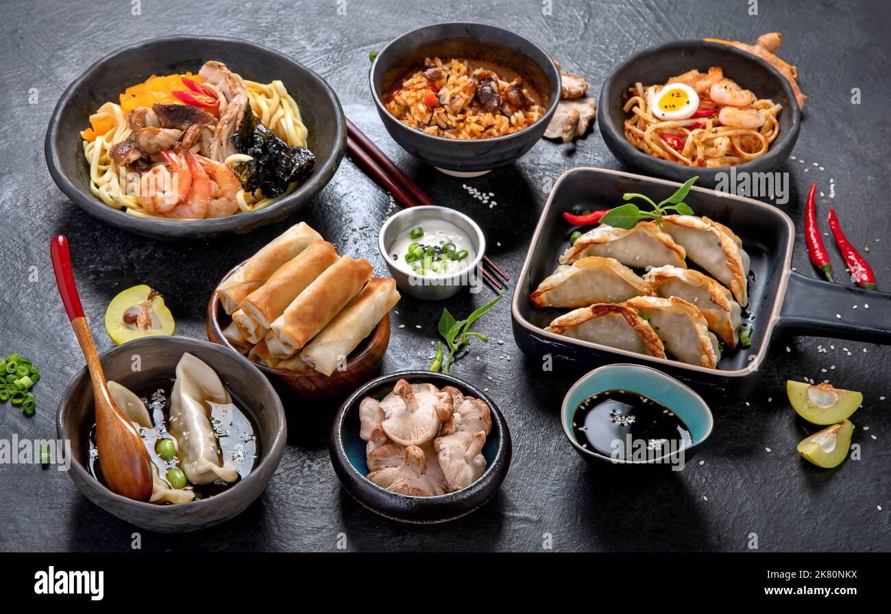 Traditional Asian food. Various of asian meals on dark background ...