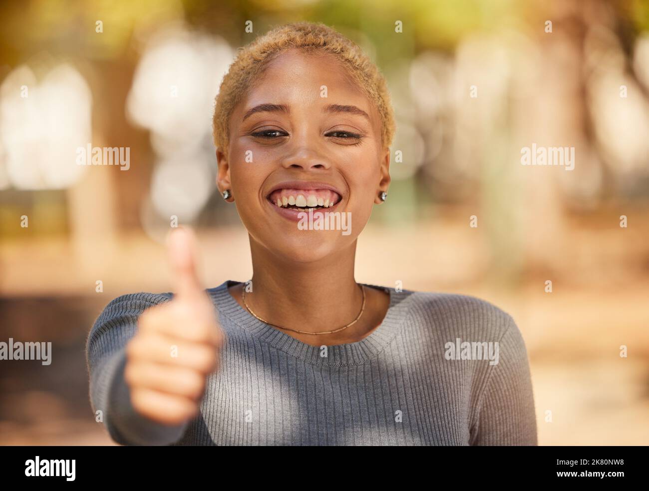 Thumbs up, support and woman with a thank you hand sign in nature. Face ...