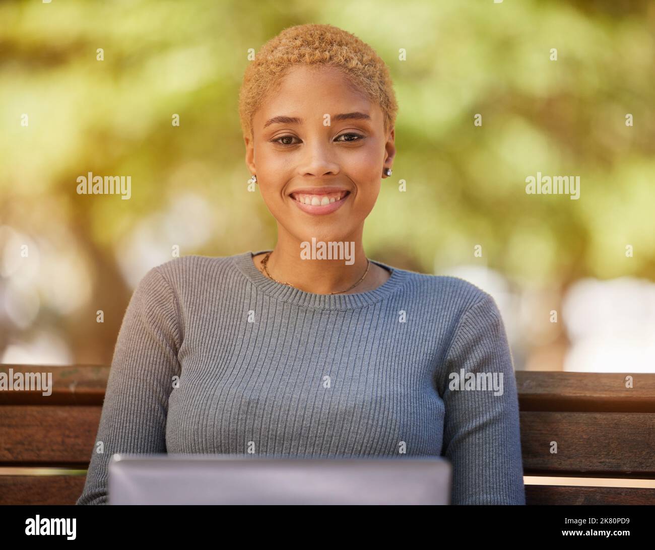 Laptop, smile and woman with internet at a park, working and typing ...
