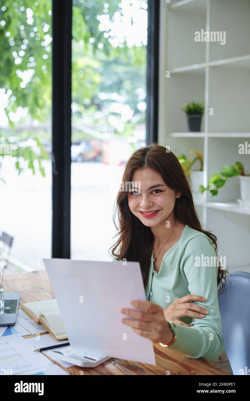 f girl, showing smiling faces while working on financial documents ...