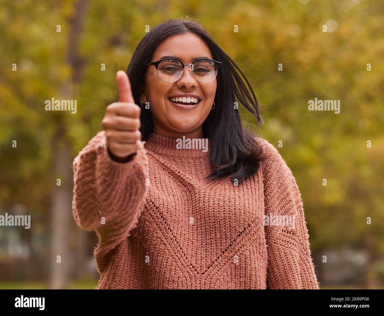 Thumbs up, like and Indian woman in park for outdoor support, volunteer in eco environment or ...