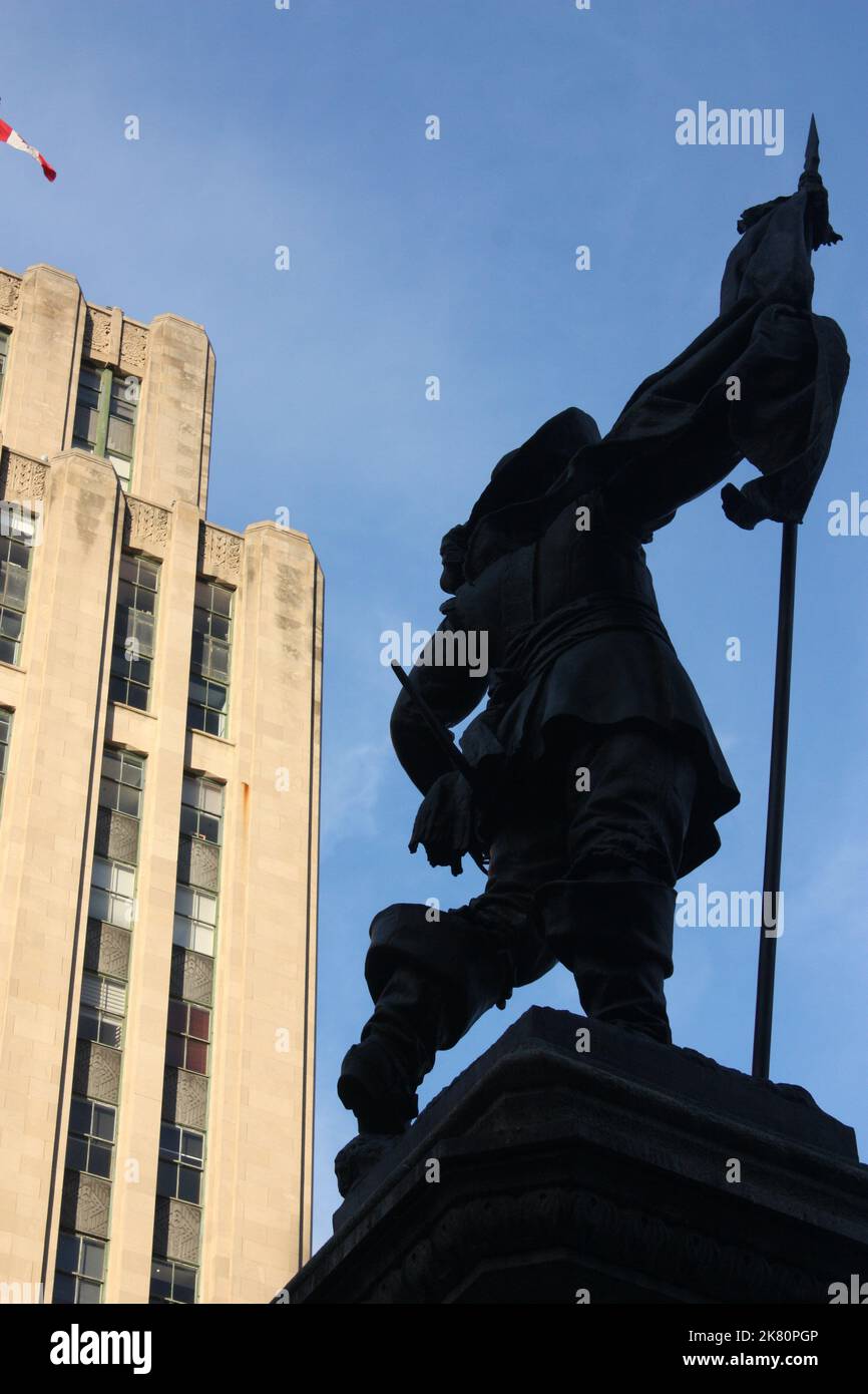 The silhouette of the Monument Maisonneuve in Place D'Armes with the ...