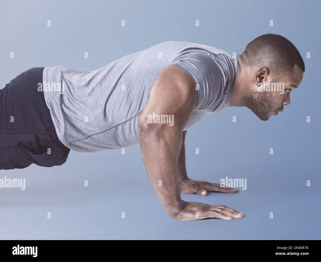 Building a stronger back and shoulders. a handsome young man doing ...