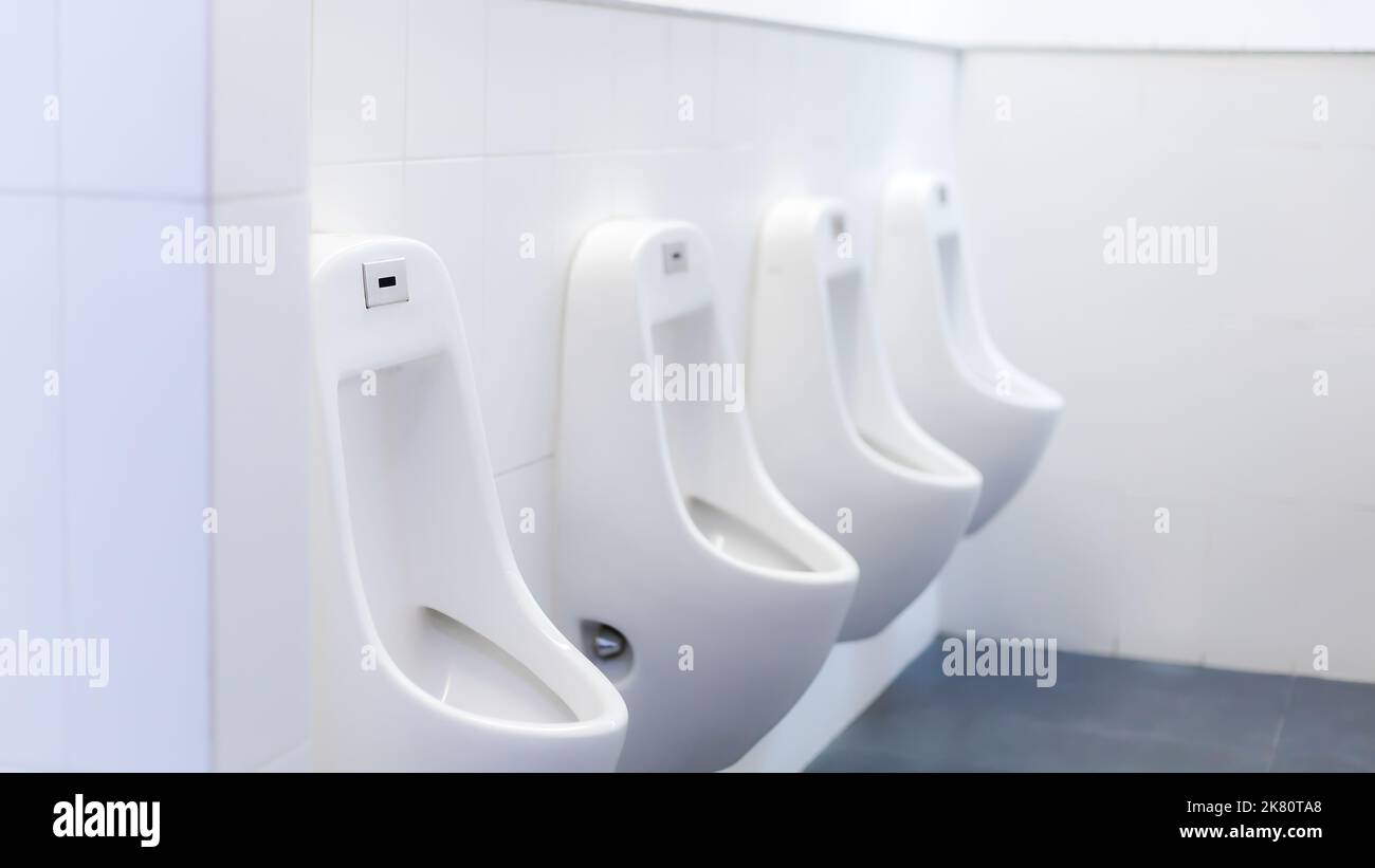public toilet clean modern white tiles urinal Stock Photo - Alamy