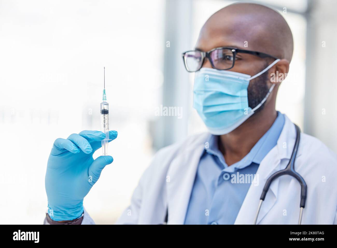 Our research has finally paid off. a young doctor holding a syringe ...