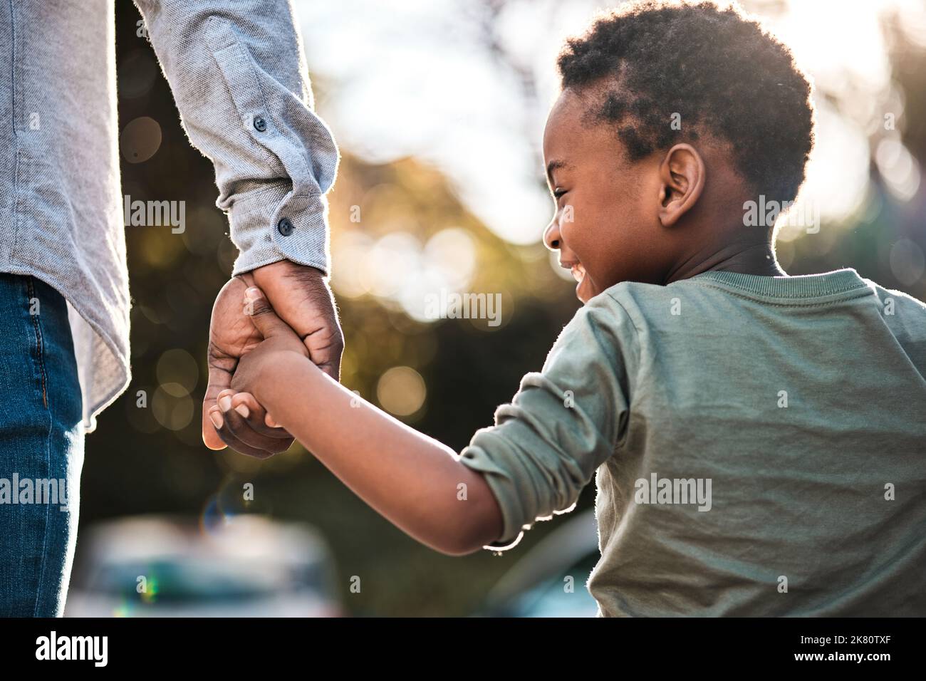 Boy walking behind dad hi-res stock photography and images - Alamy