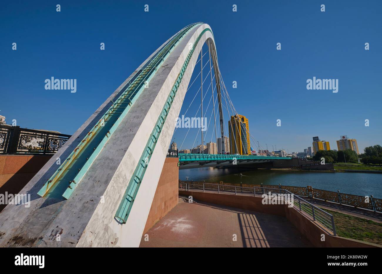 A view of the modern, curved, cable suspended bridge over the Ishim ...