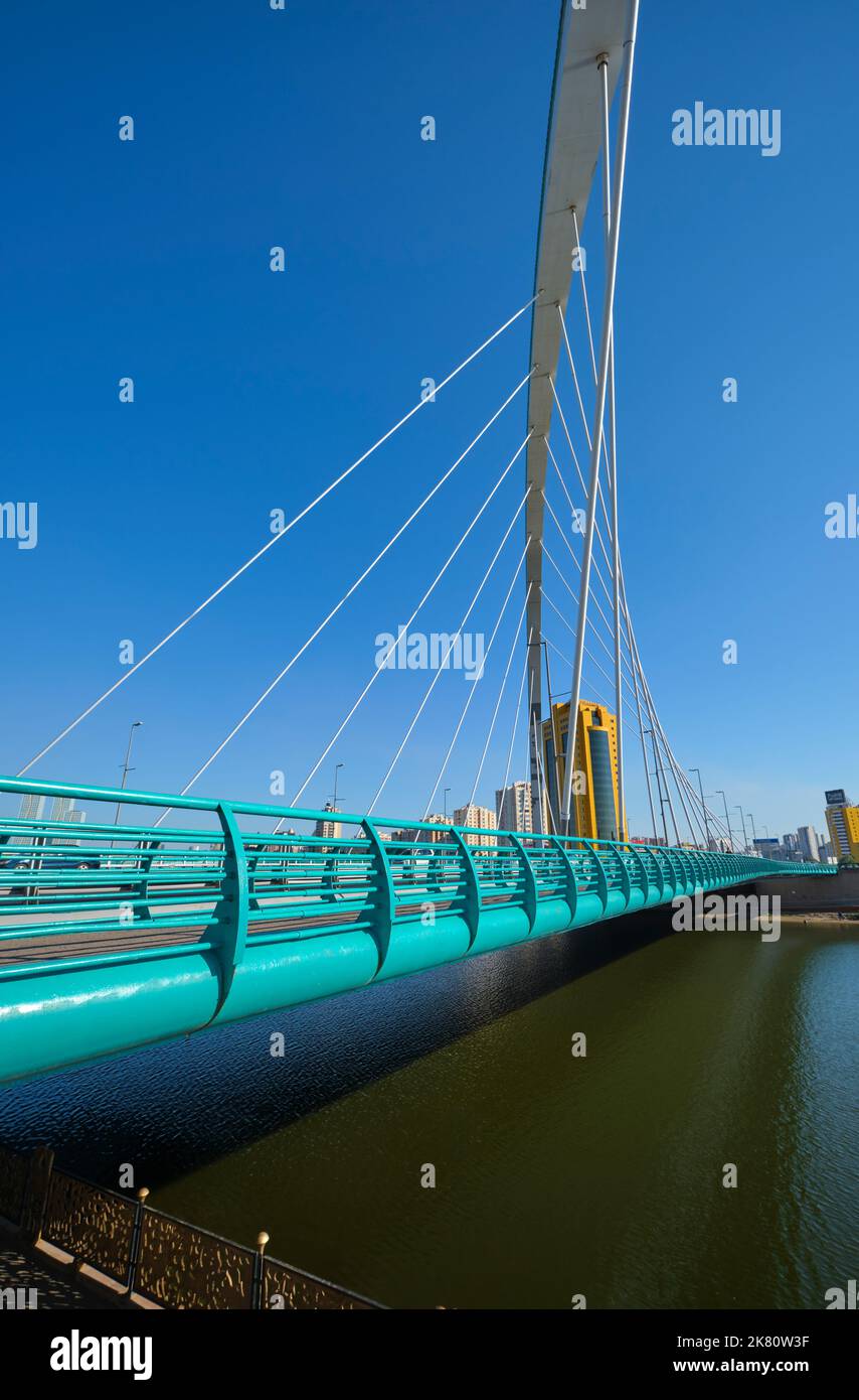 A view of the modern, curved, cable suspended bridge over the Ishim ...