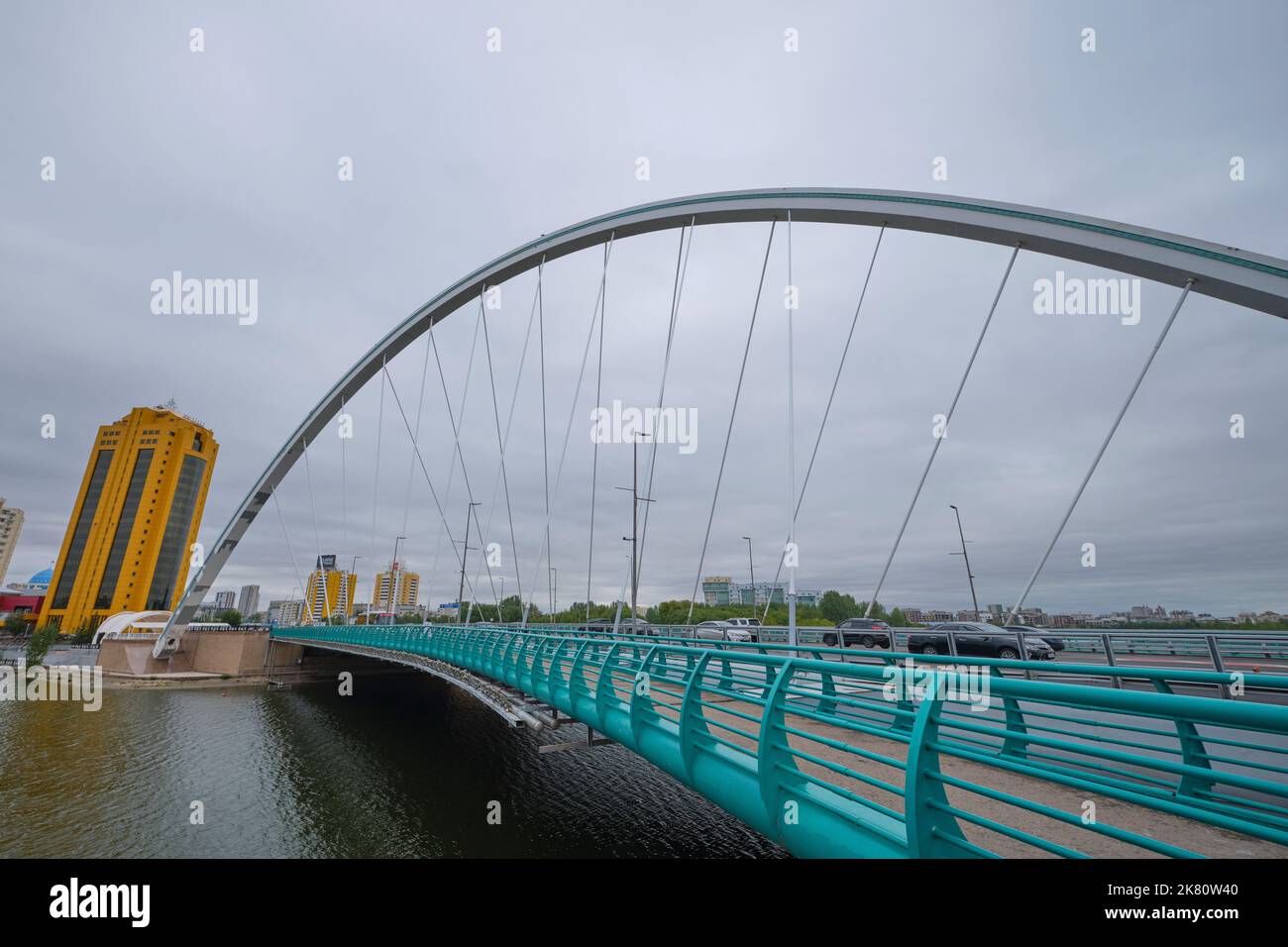 A view of the modern, curved, cable suspended bridge over the Ishim ...