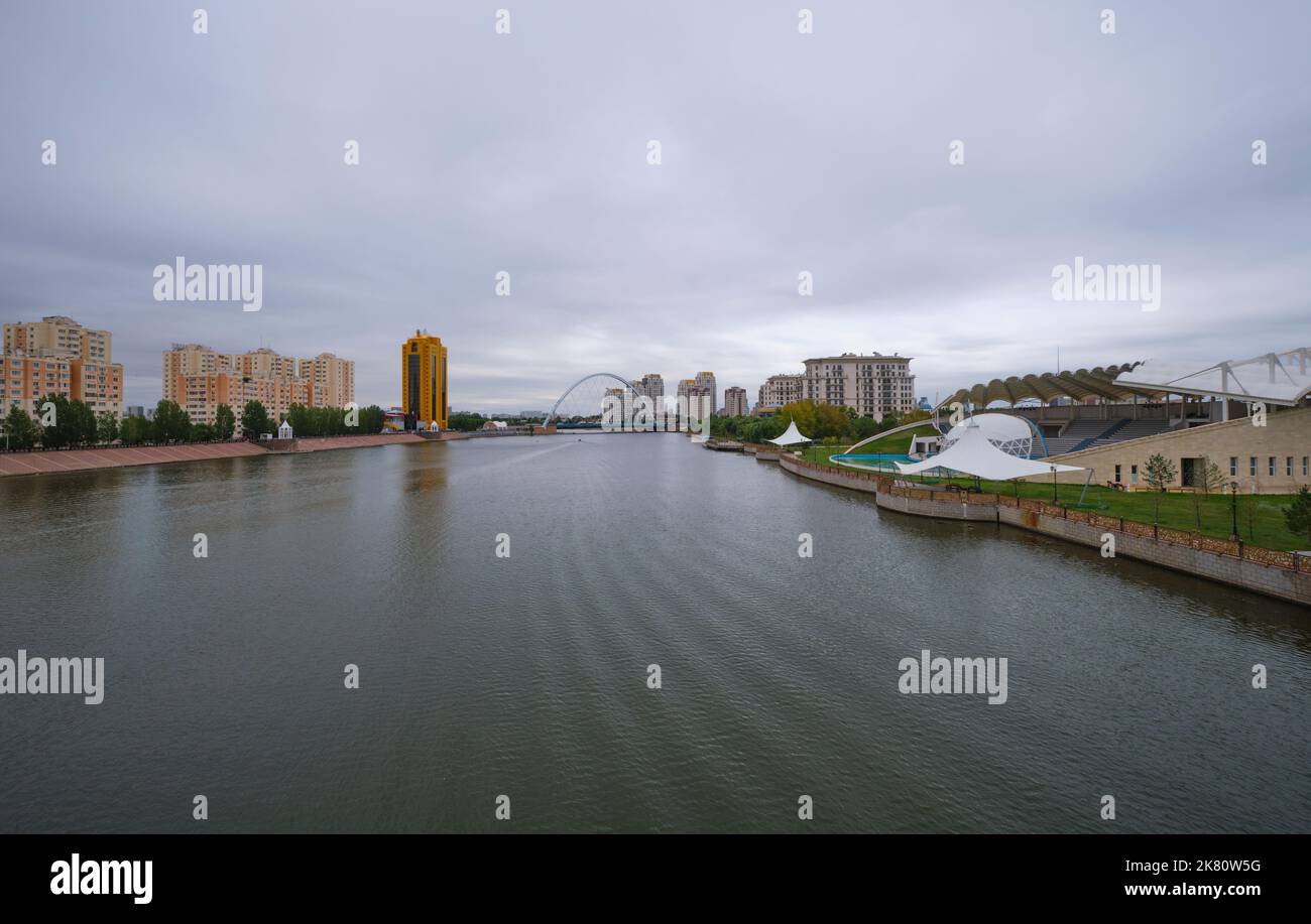 A view of the modern, curved, cable suspended bridge over the Ishim ...