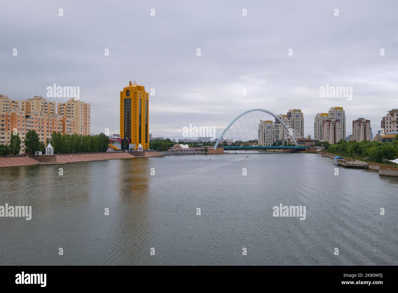 A view of the modern, curved, cable suspended bridge over the Ishim ...