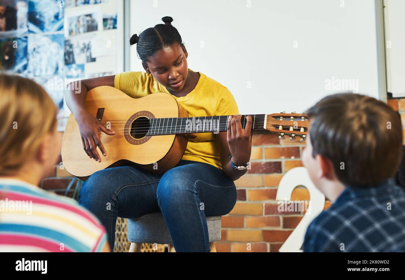 Weve got a future musician among us. a young girl sitting and playing ...