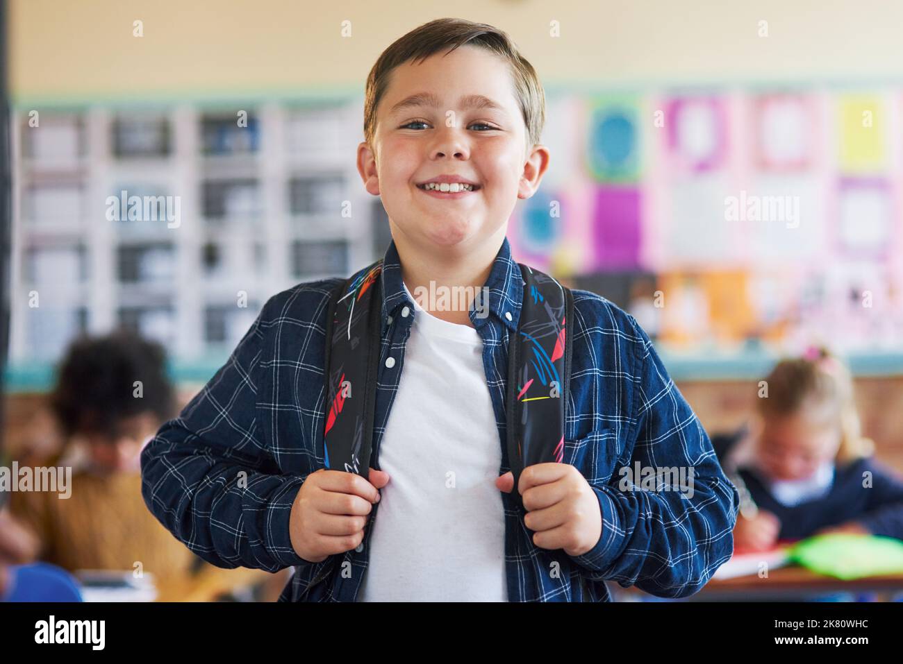 School is my favourite part of the day. a young boy standing in his ...