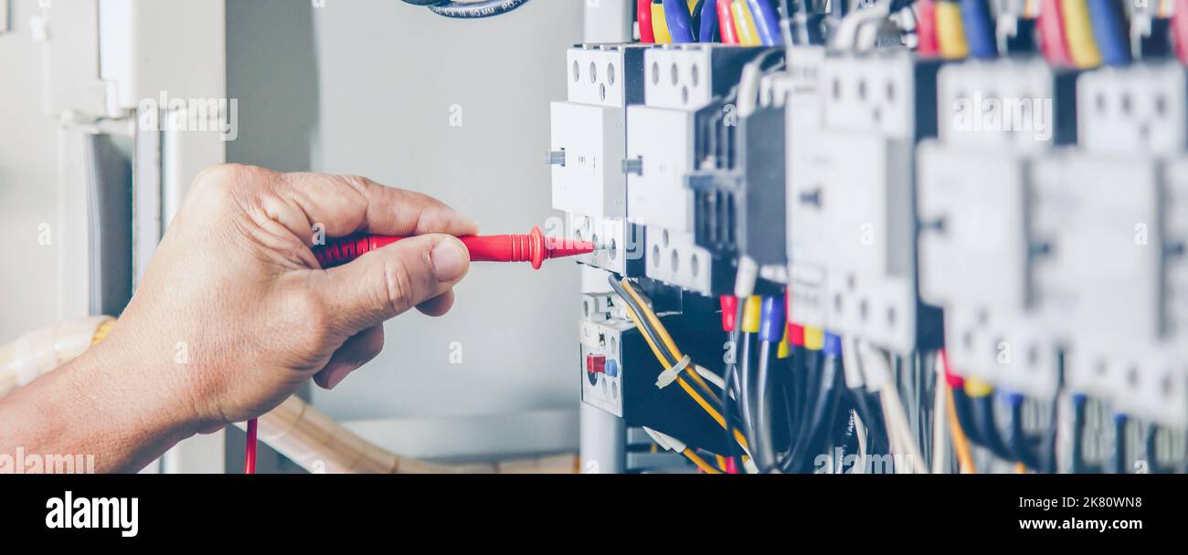 Electrical engineer checking the operation of electrical control ...