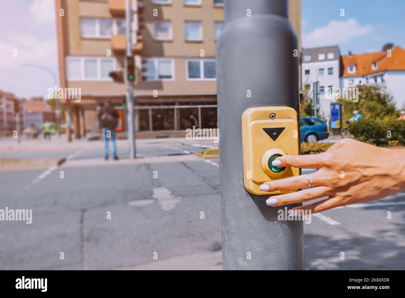 Aware passenger presses the traffic light control button to safely ...