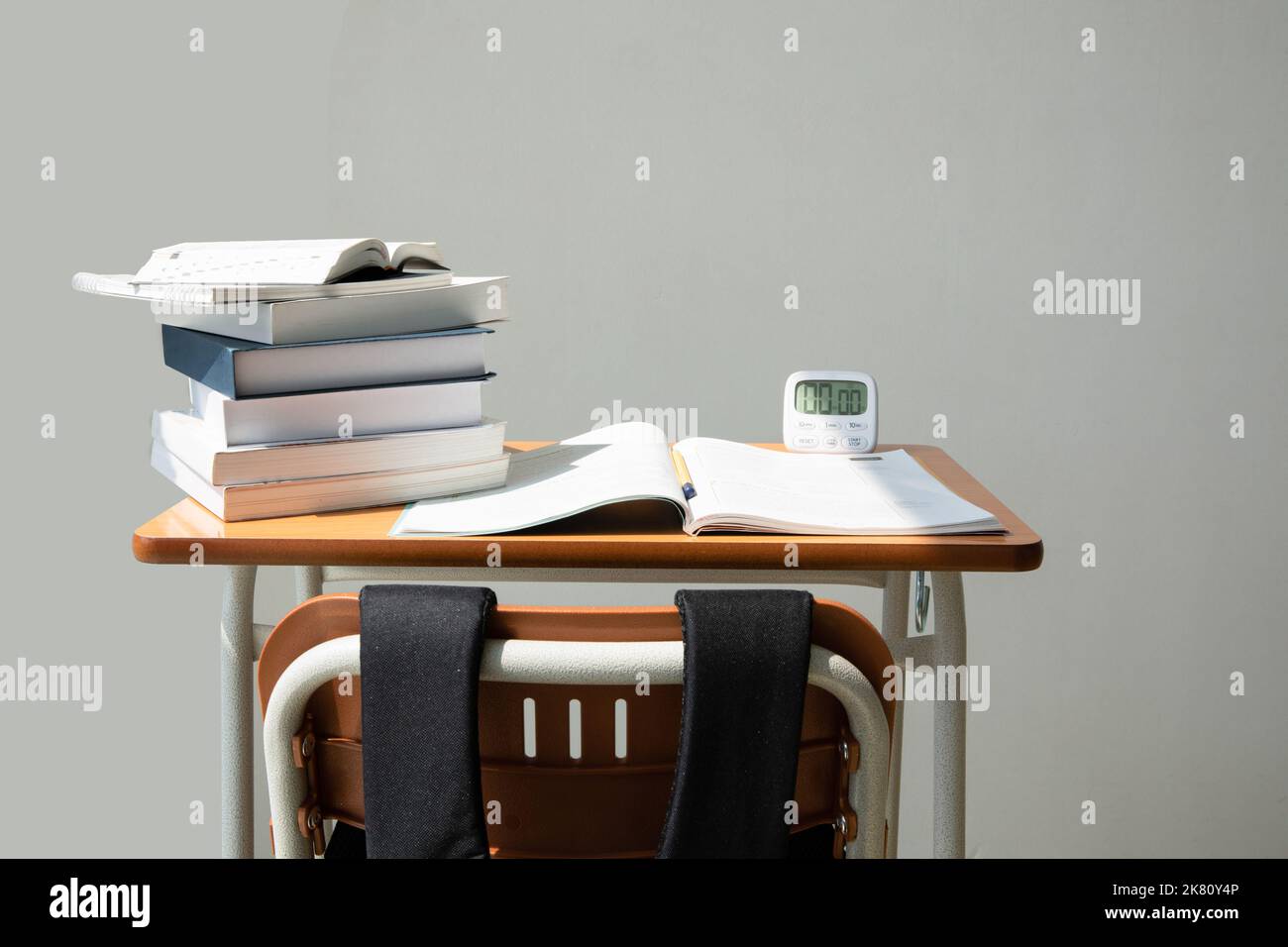 studying at home, study desk setup stack of workbooks Stock Photo - Alamy