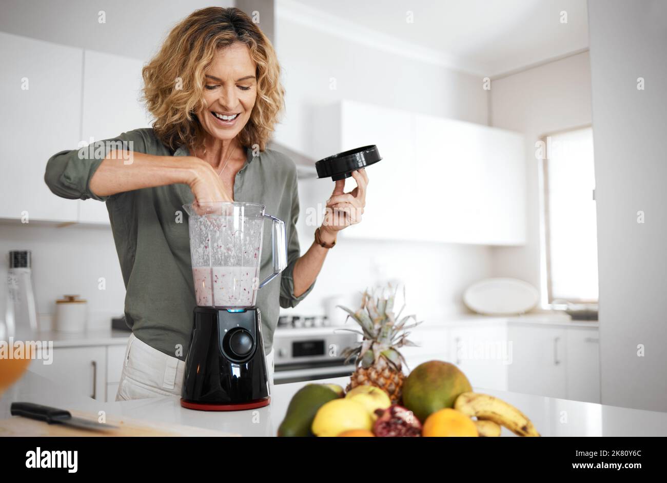 We always have to check our smoothies. a woman tasting her smoothie ...